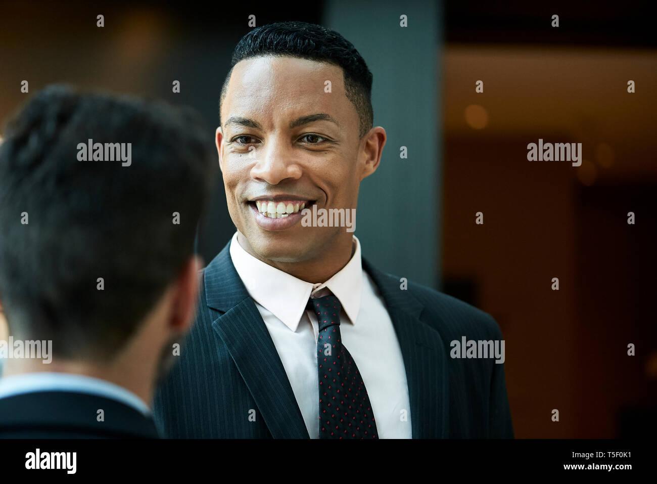 Businessman talking with his colleague in hotel Stock Photo - Alamy