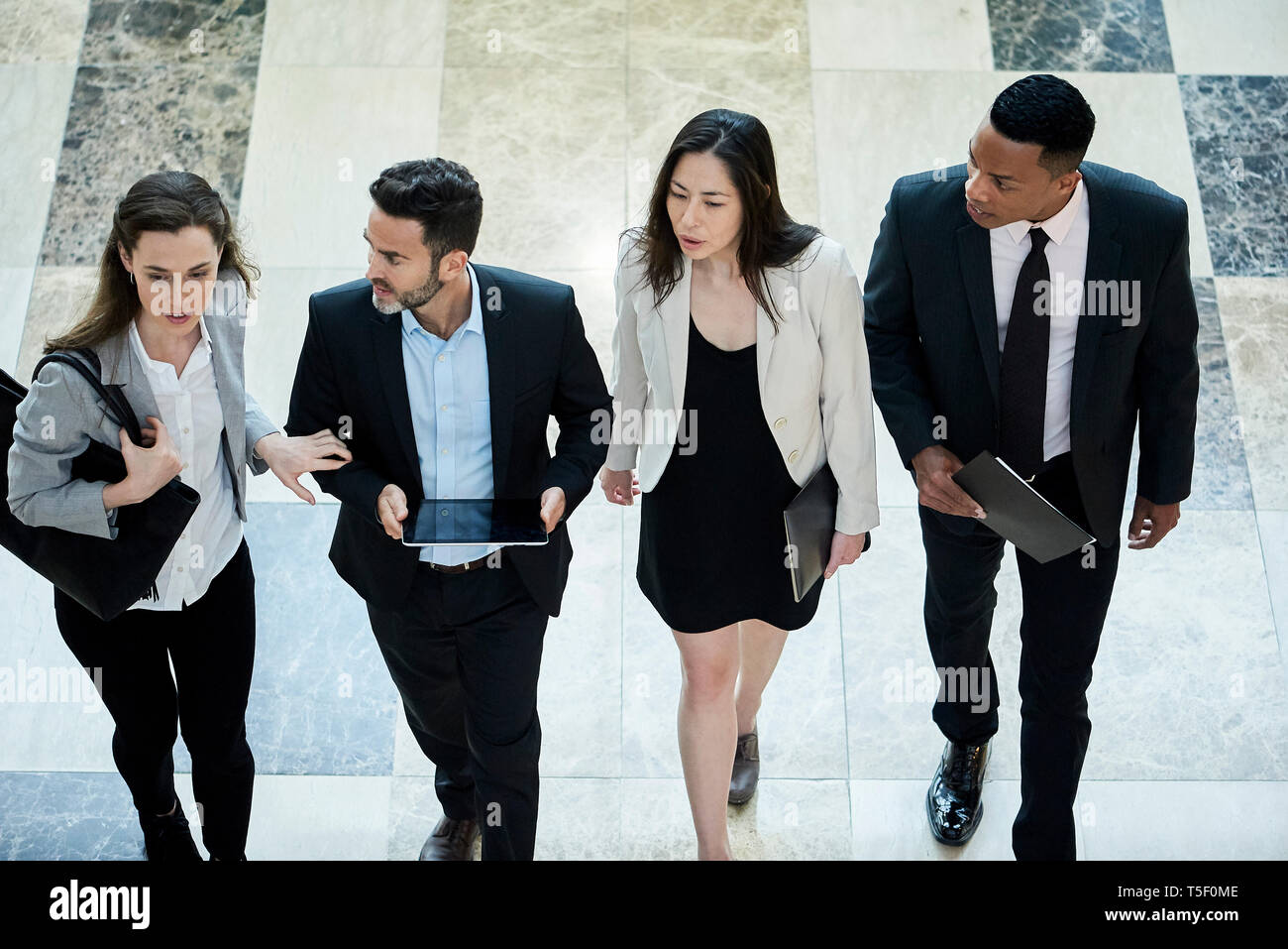 Business people walking in hotel lobby Stock Photo - Alamy