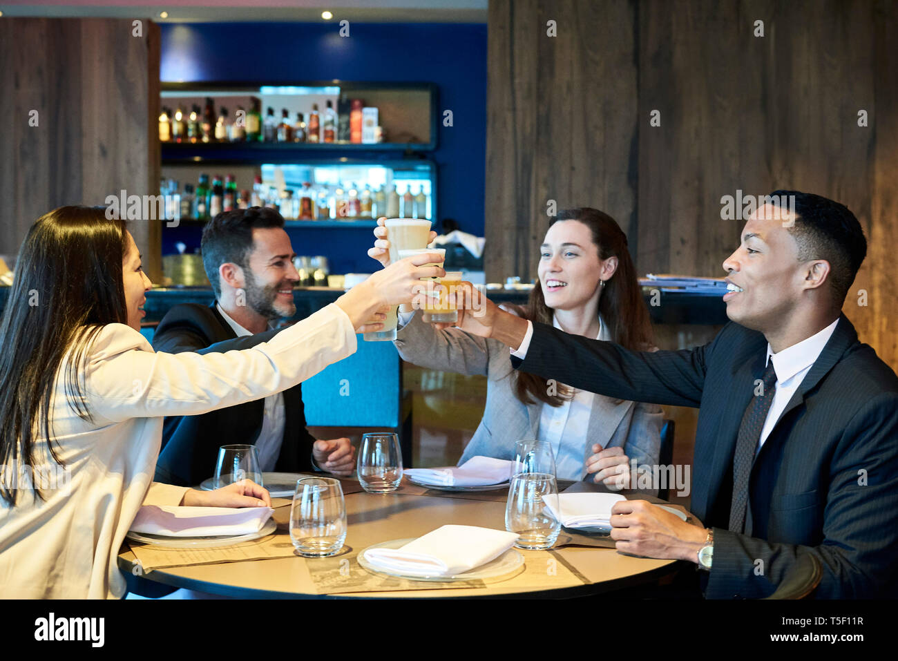 Business people toasting drink in bar Stock Photo - Alamy