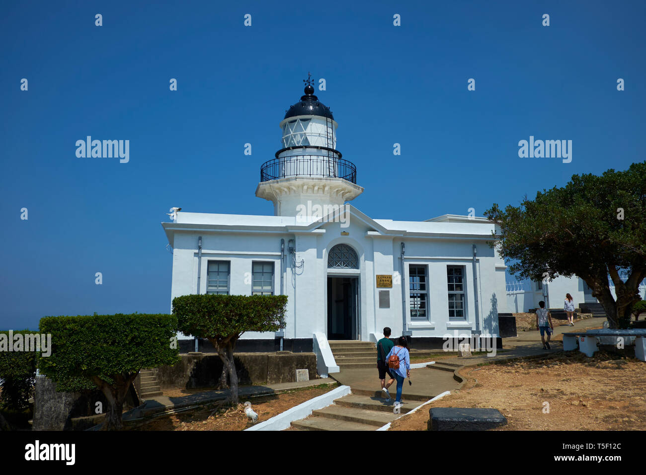 A classic, whitewashed lighthouse, still in use. On a hilltop on Cijin ...