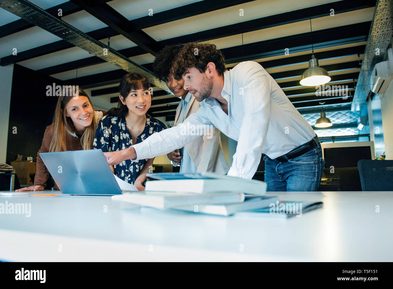 Business people using laptop in office Stock Photo - Alamy