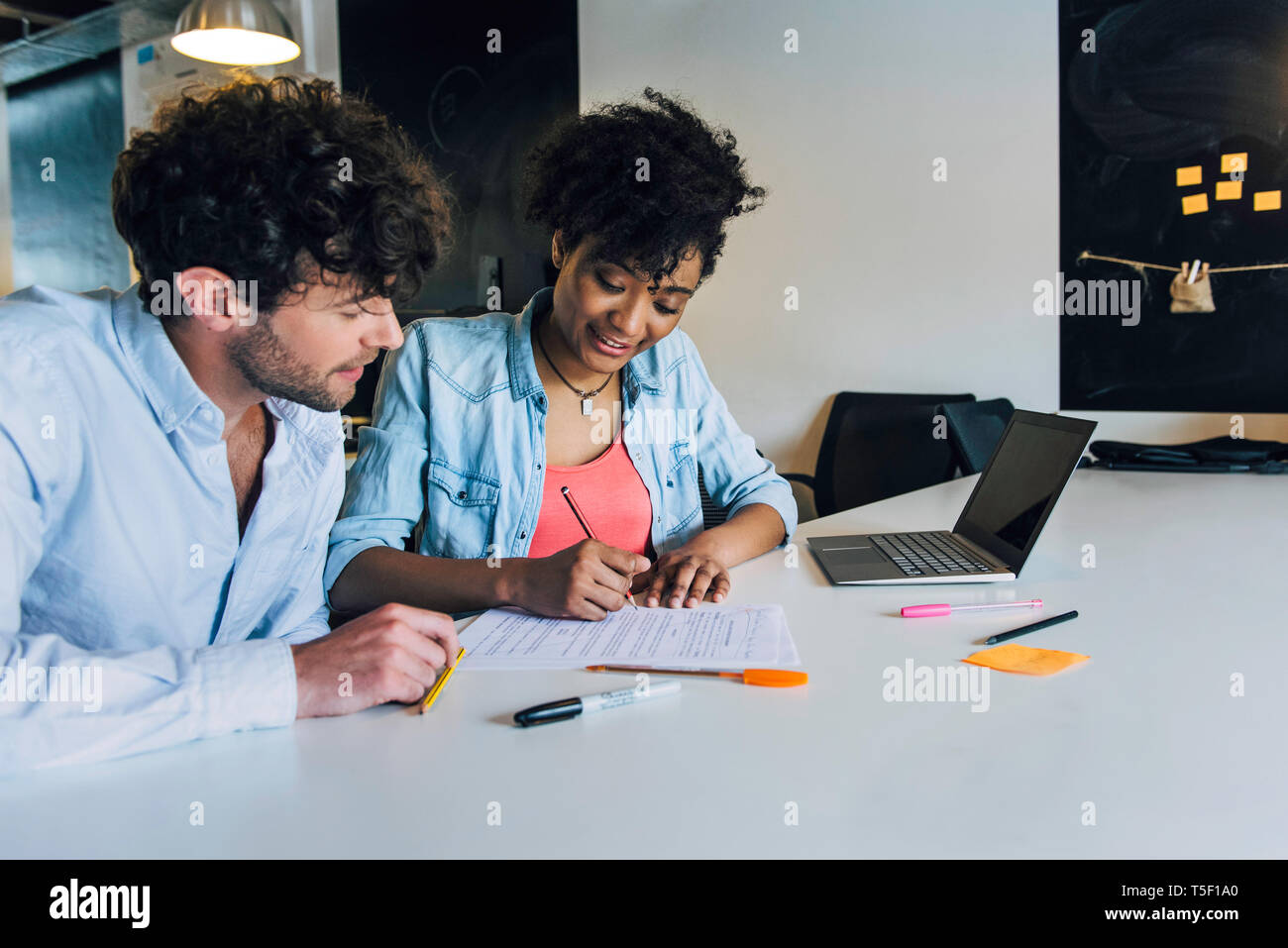 Sitting working concentration teamwork hi-res stock photography and ...