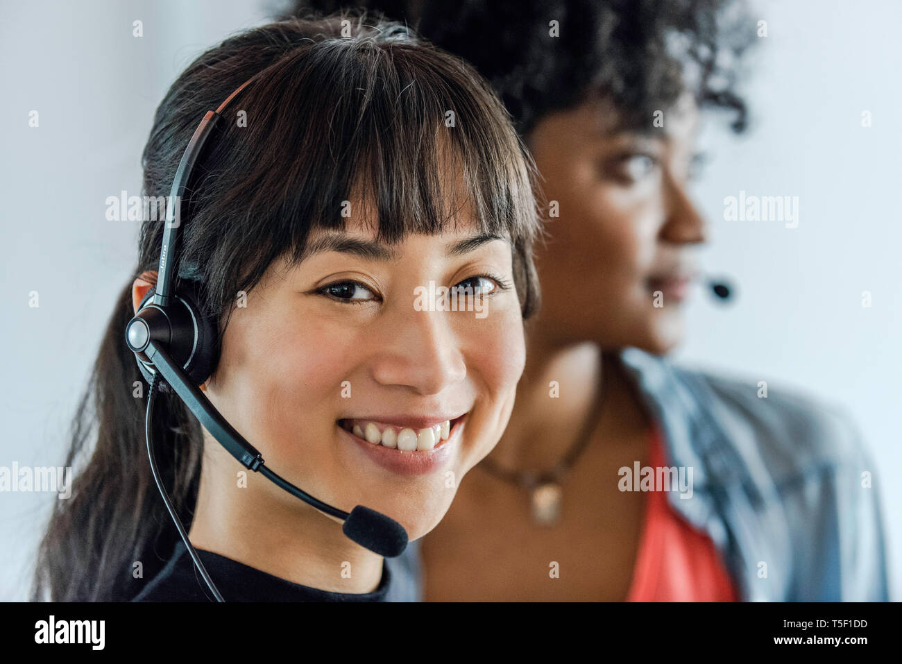 Businesswoman wearing headset smiling hi-res stock photography and images - Alamy