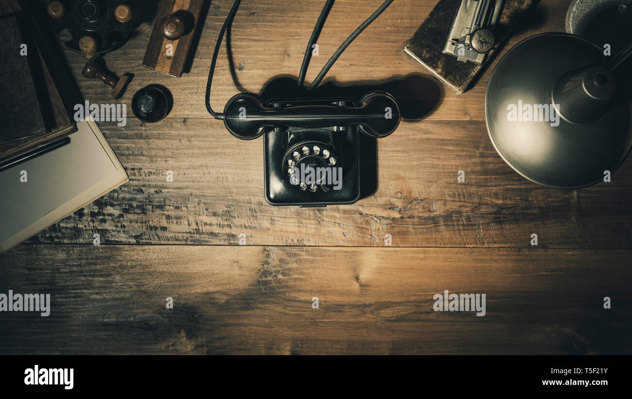 Vintage office desktop with telephone at night, waiting for the phone ...