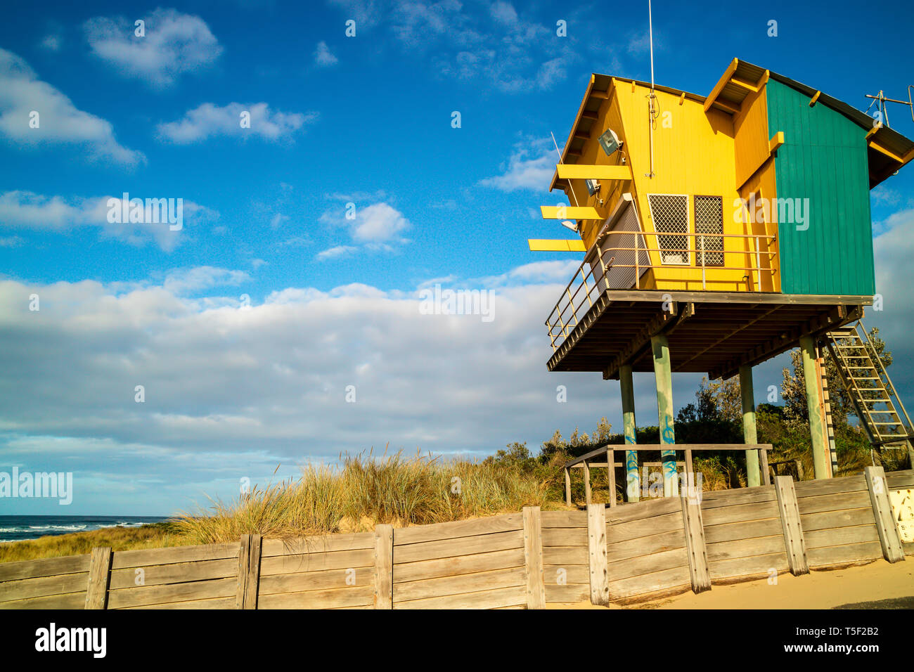 Brightly coloured lifeguard observation tower on sandy beach of Tasman ...