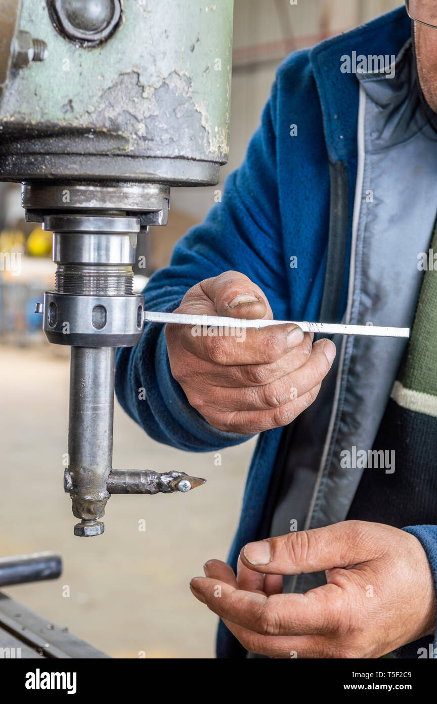 Hands of an old worker using milling machine in factory workshop Stock ...