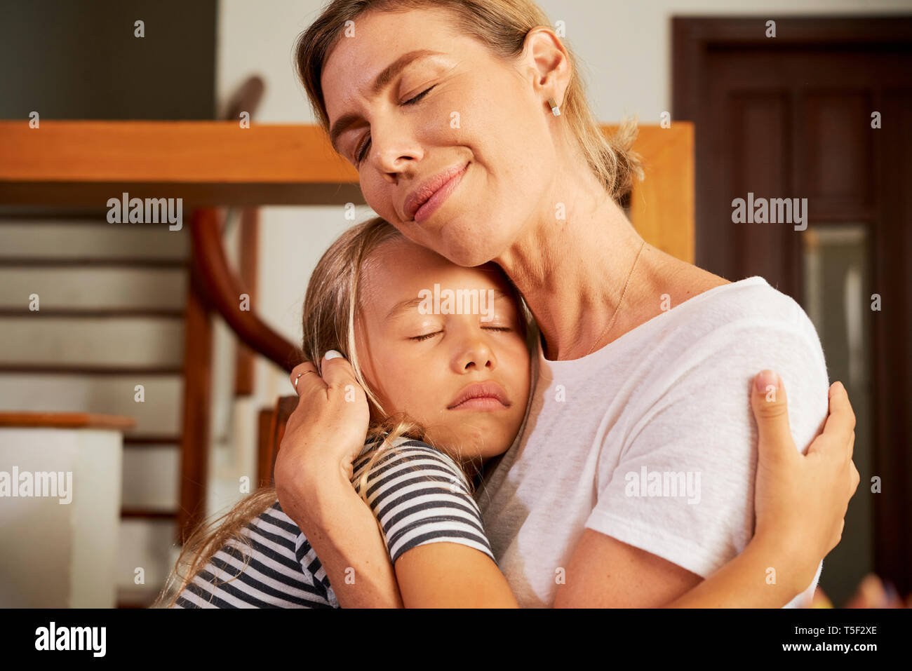 Girl hugging mother Stock Photo - Alamy