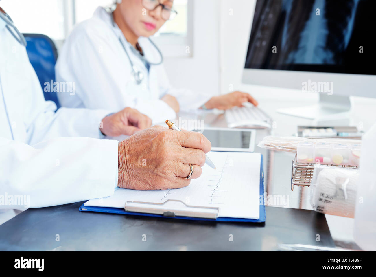 Cardiologist checking patients test results Stock Photo - Alamy