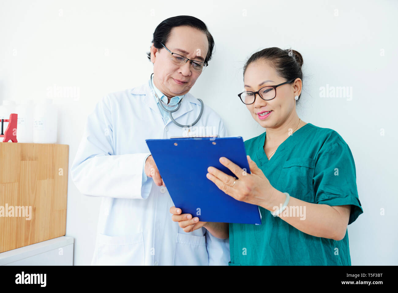 Doctor Reading Document High Resolution Stock Photography and Images ...