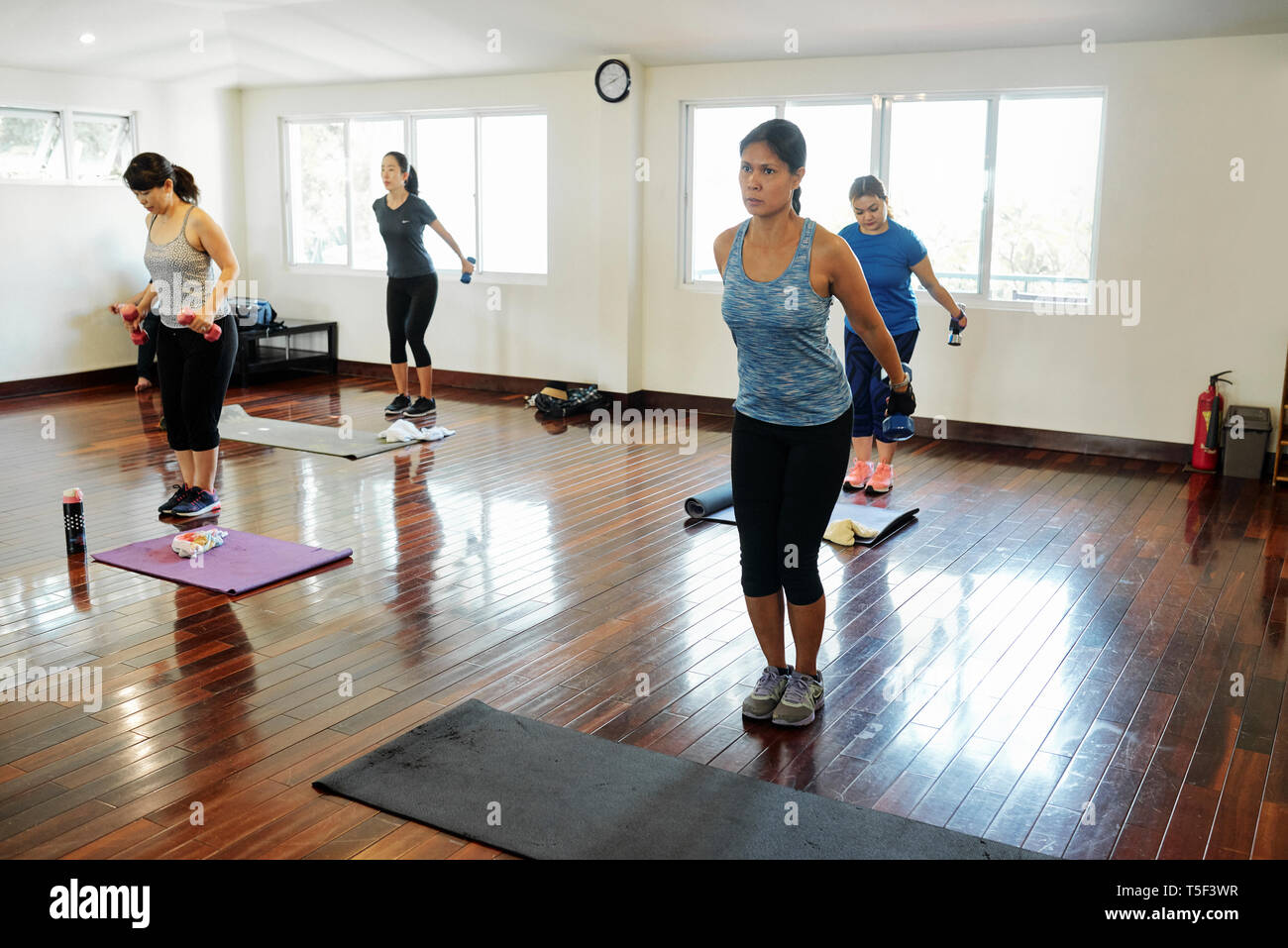 Fitness group people lifting dumbbell hi-res stock photography and ...