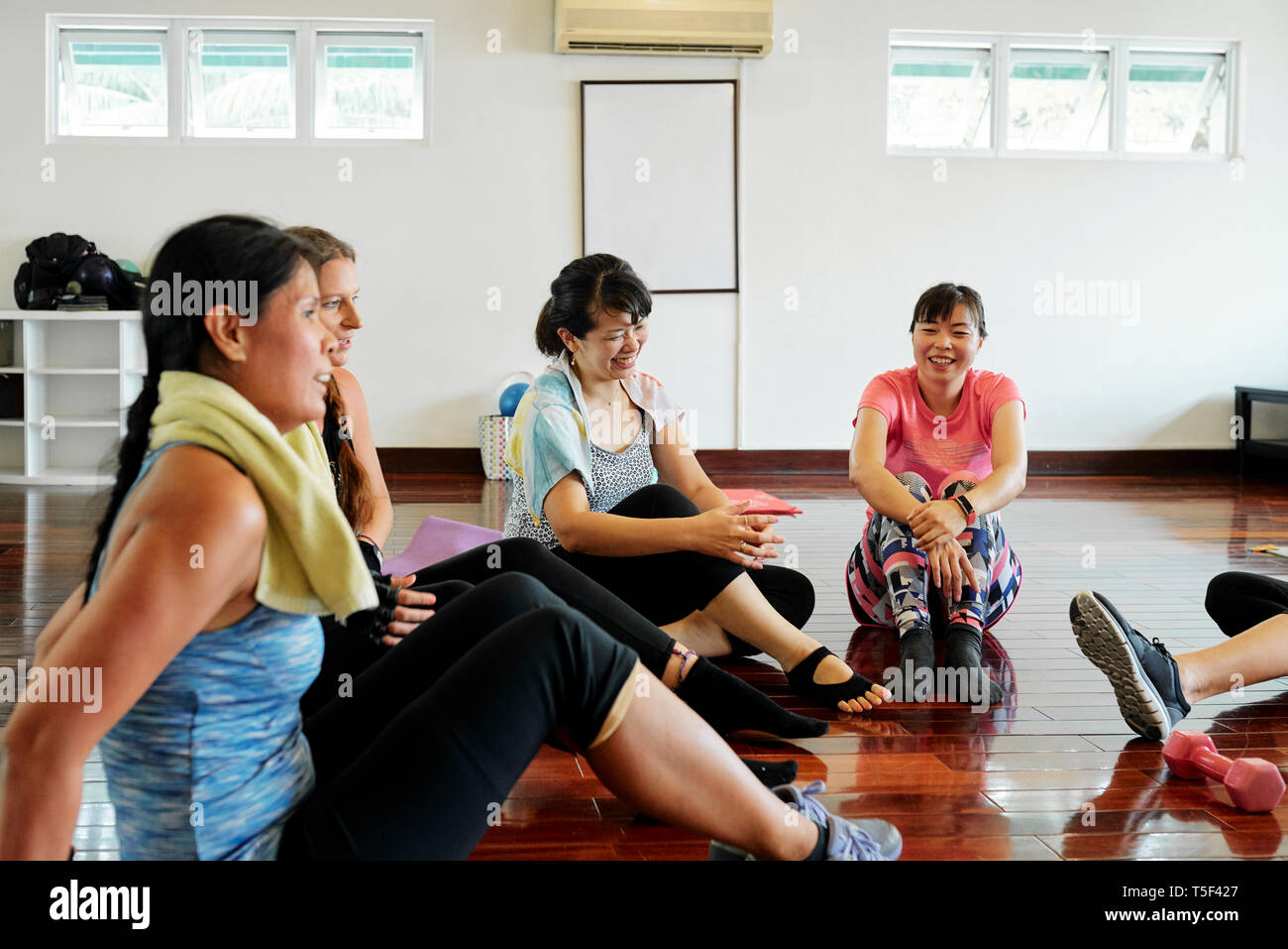 Talking young women in gym Stock Photo - Alamy