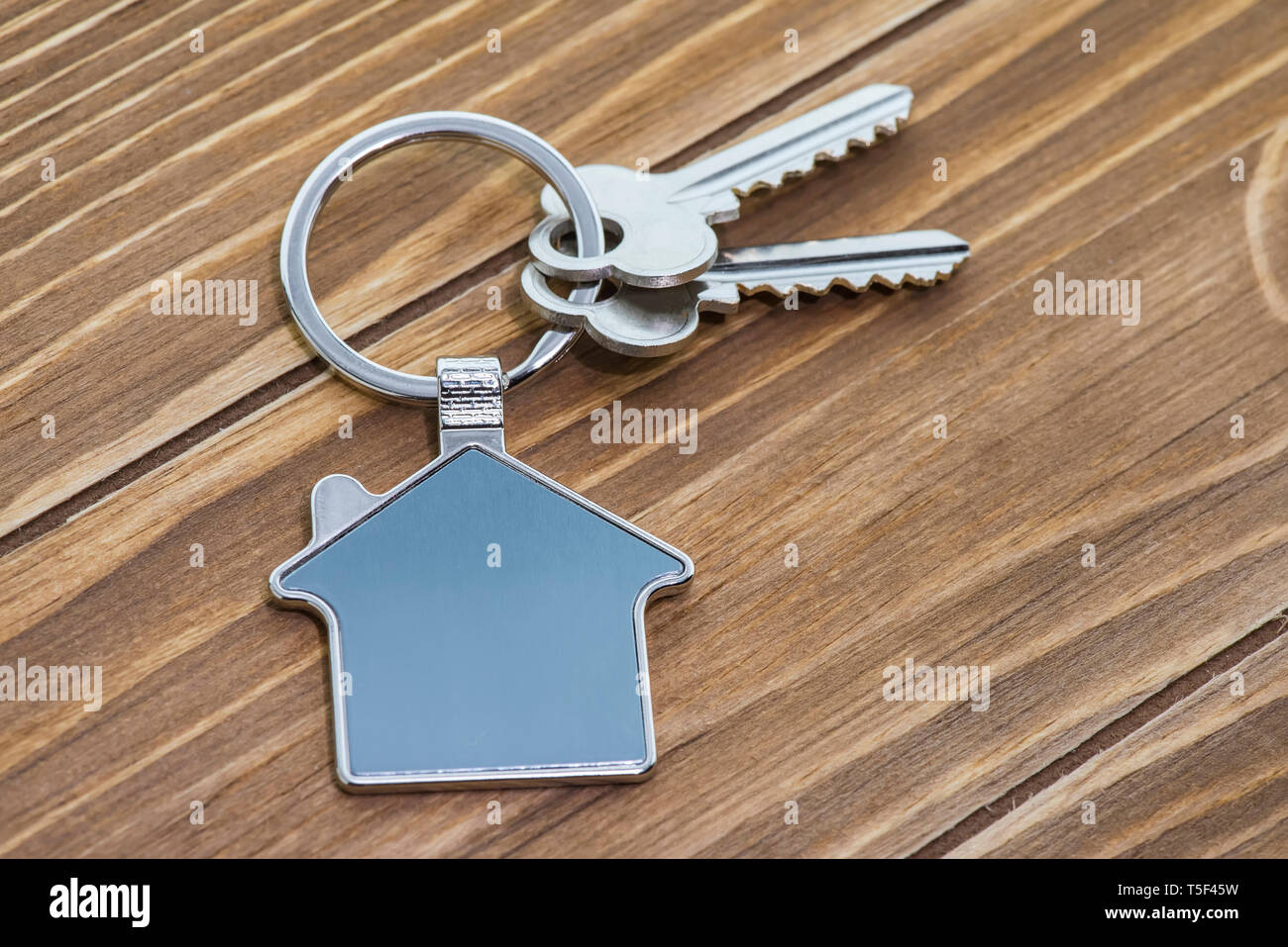 key chain with house symbol and key,Real estate concept Stock Photo - Alamy