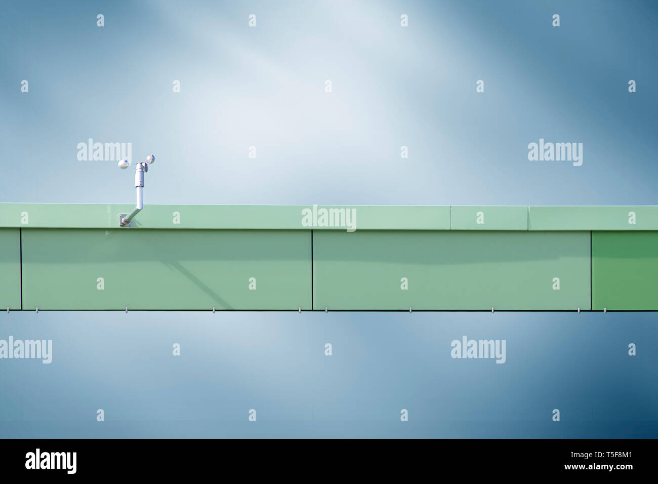 The photograph of the propeller of a wind sensor on the roof edge of a ...