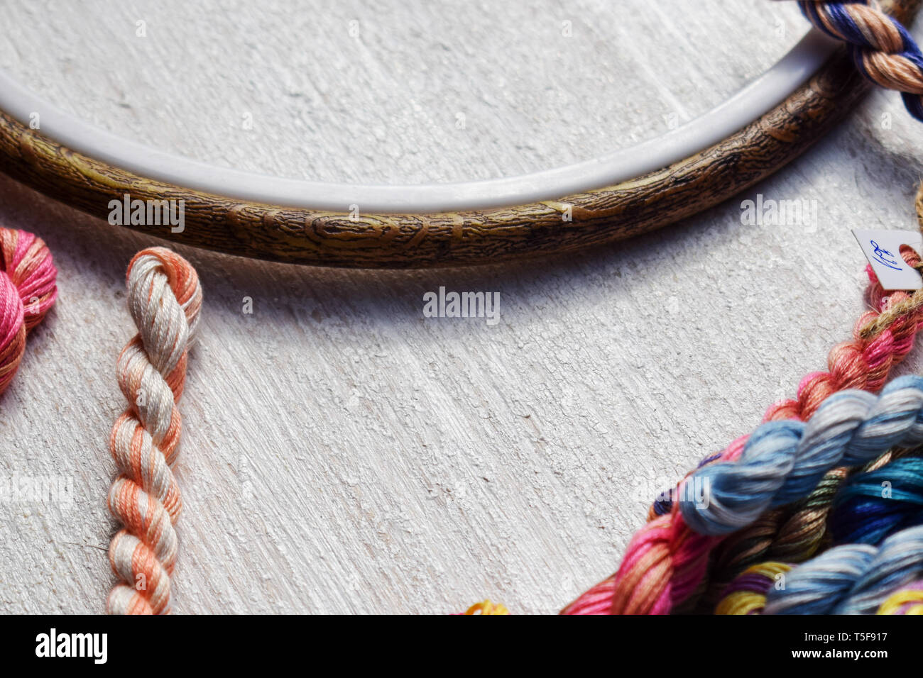 Embroidery hoop and floss braided threads on a light background Stock ...