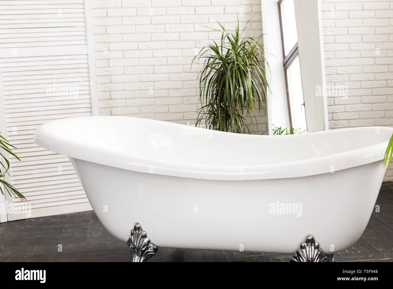 Beautiful white bath in a bright bathroom Stock Photo - Alamy