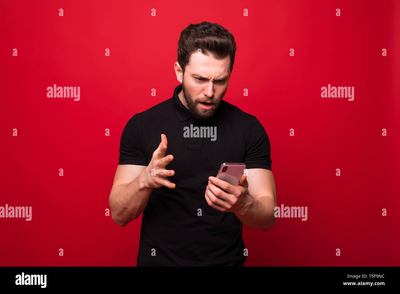 Image of screaming angry young bearded emotional man standing over red ...