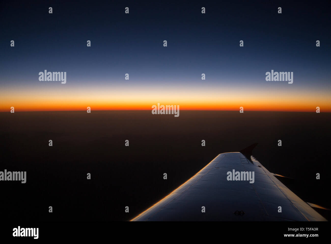 Horizon sunset view from airplane window Stock Photo - Alamy