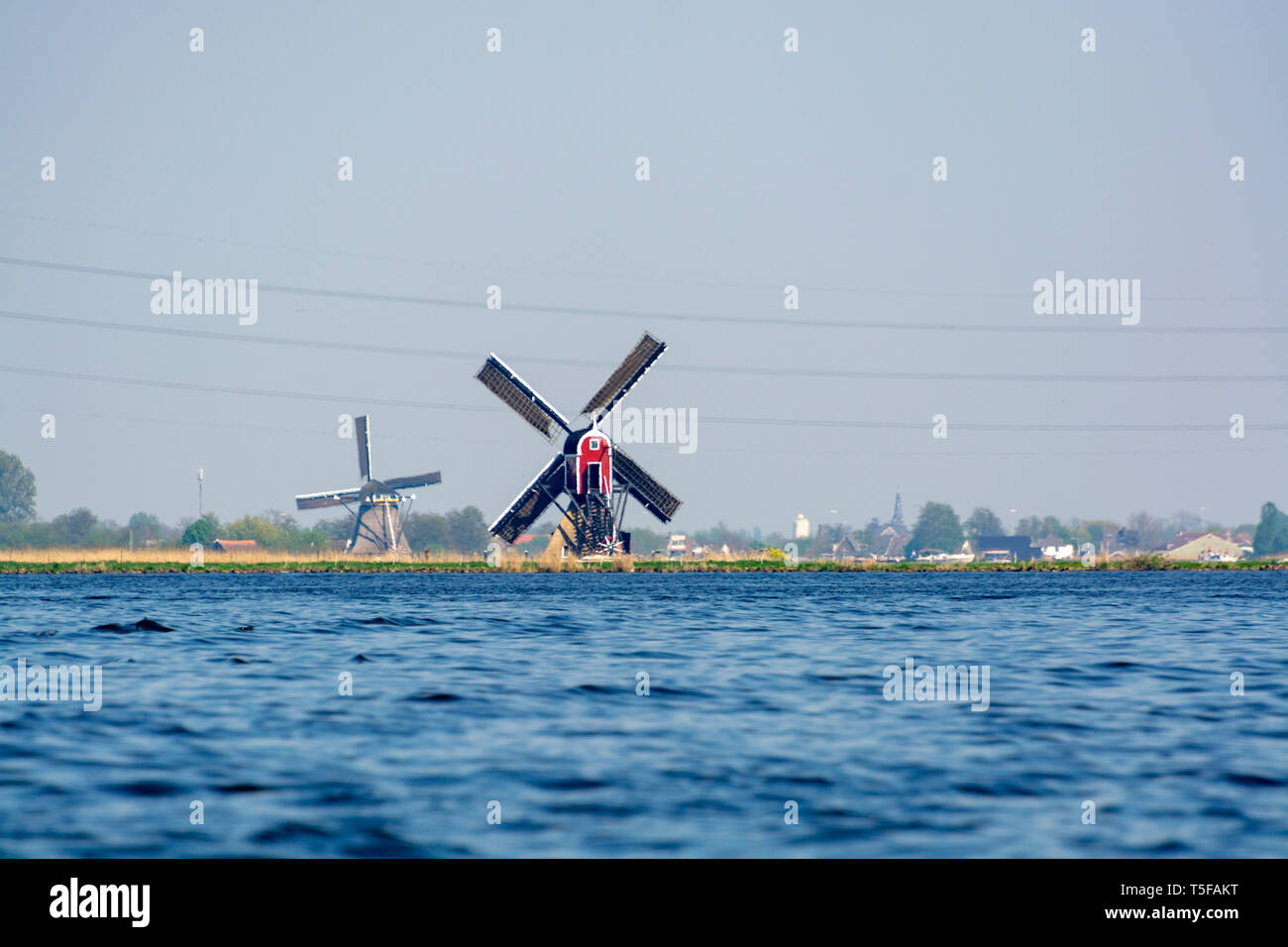Waterways of North Holland and view on traditional Dutch wind mill ...