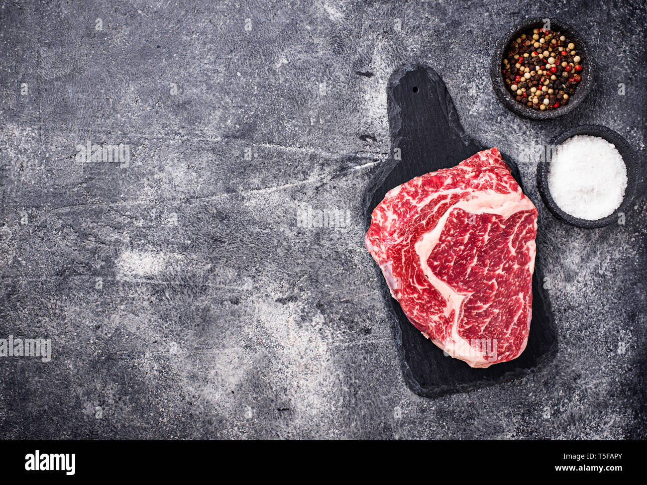 Raw marbled ribeye steak and spices Stock Photo - Alamy