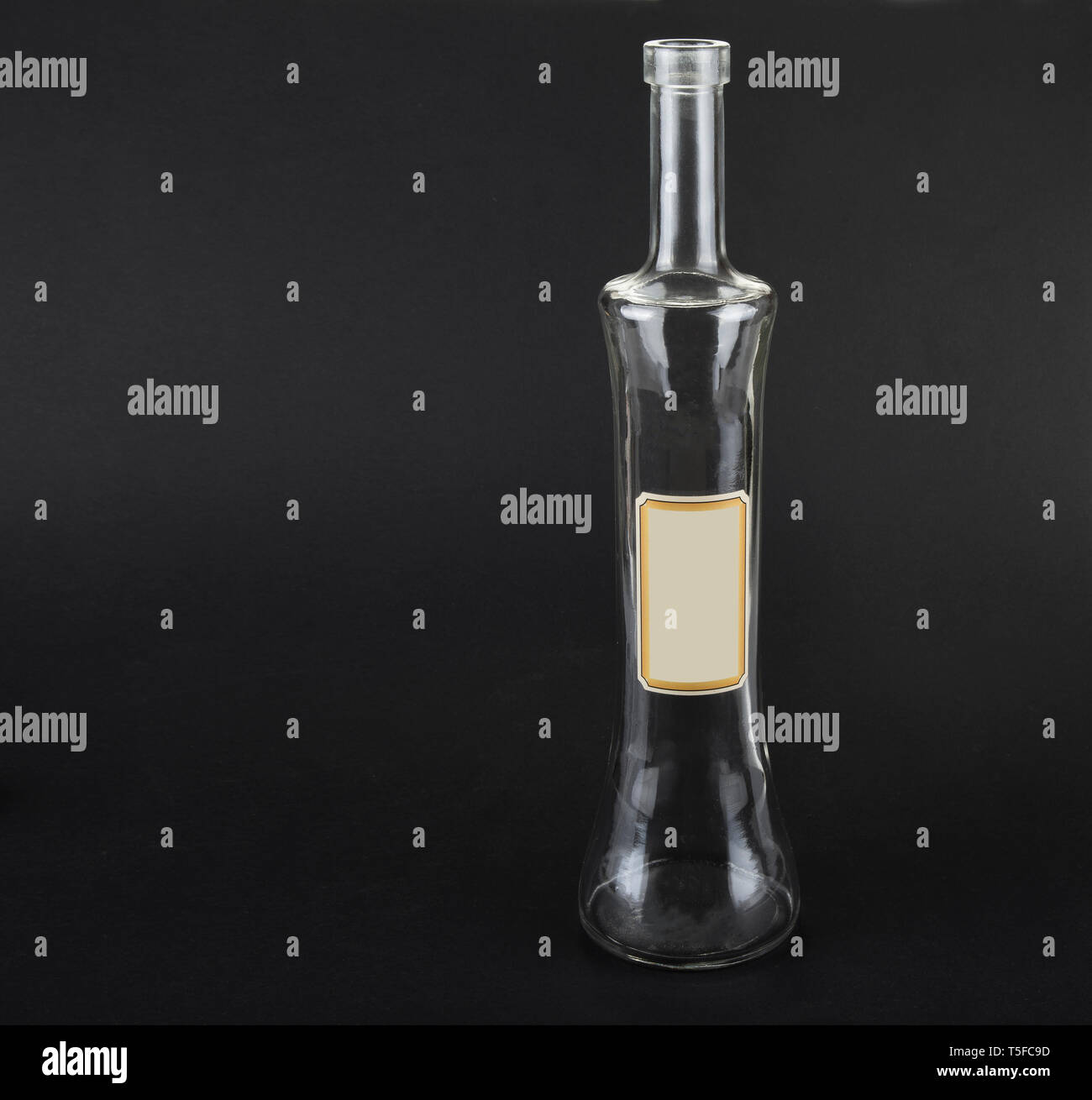 Empty spirit bottle on a black background Stock Photo - Alamy