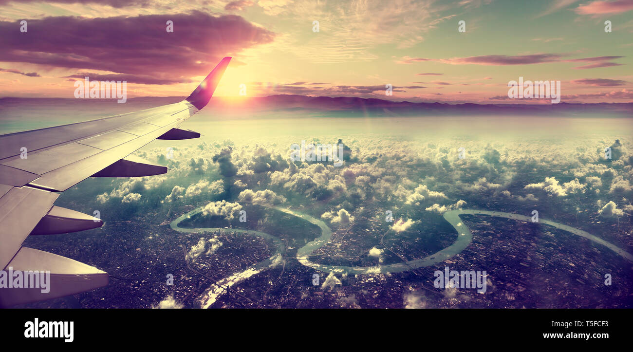 Concept of airplane travel. Flying above the city. Scenery sunset ...