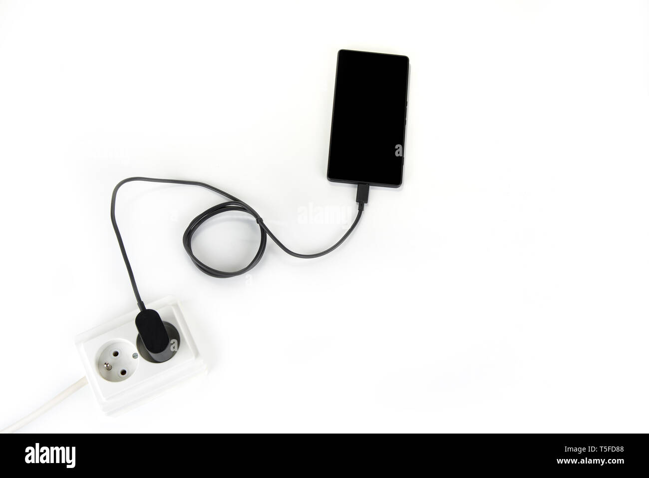 Smartphone charger plug in the socket Stock Photo - Alamy