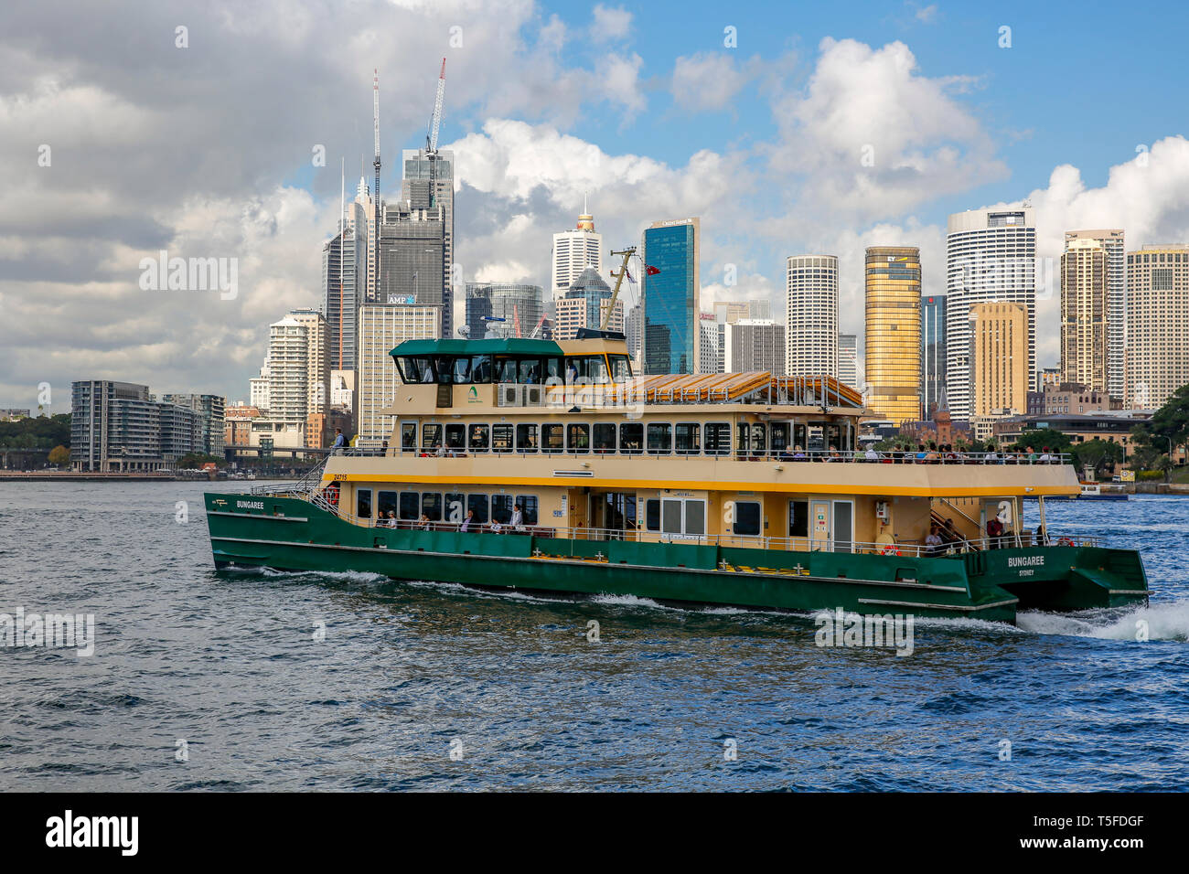 Sydney ferry on the harbour with Sydney city centre office buildings ...