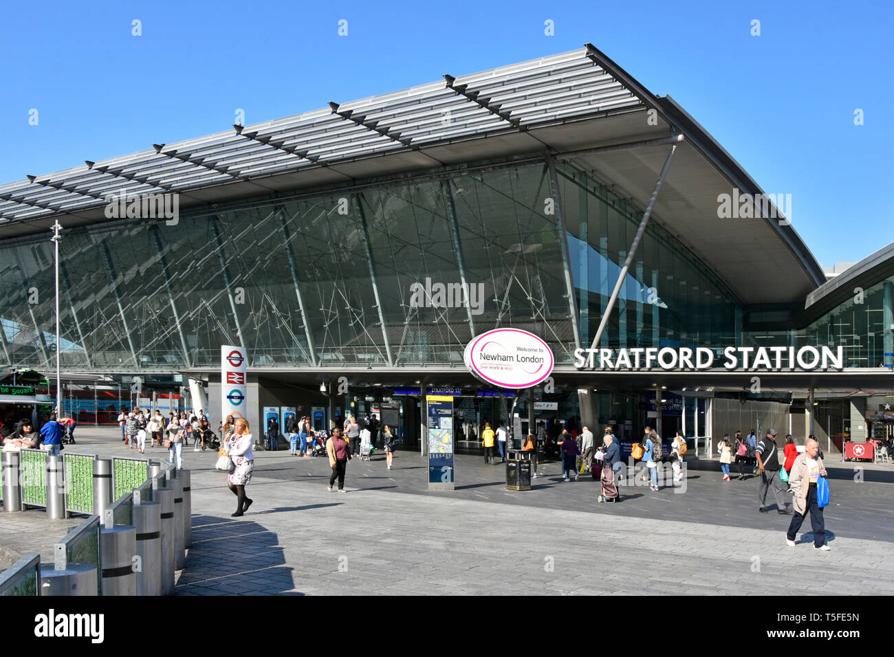 People at entrance & front glass building facade of Stratford public ...