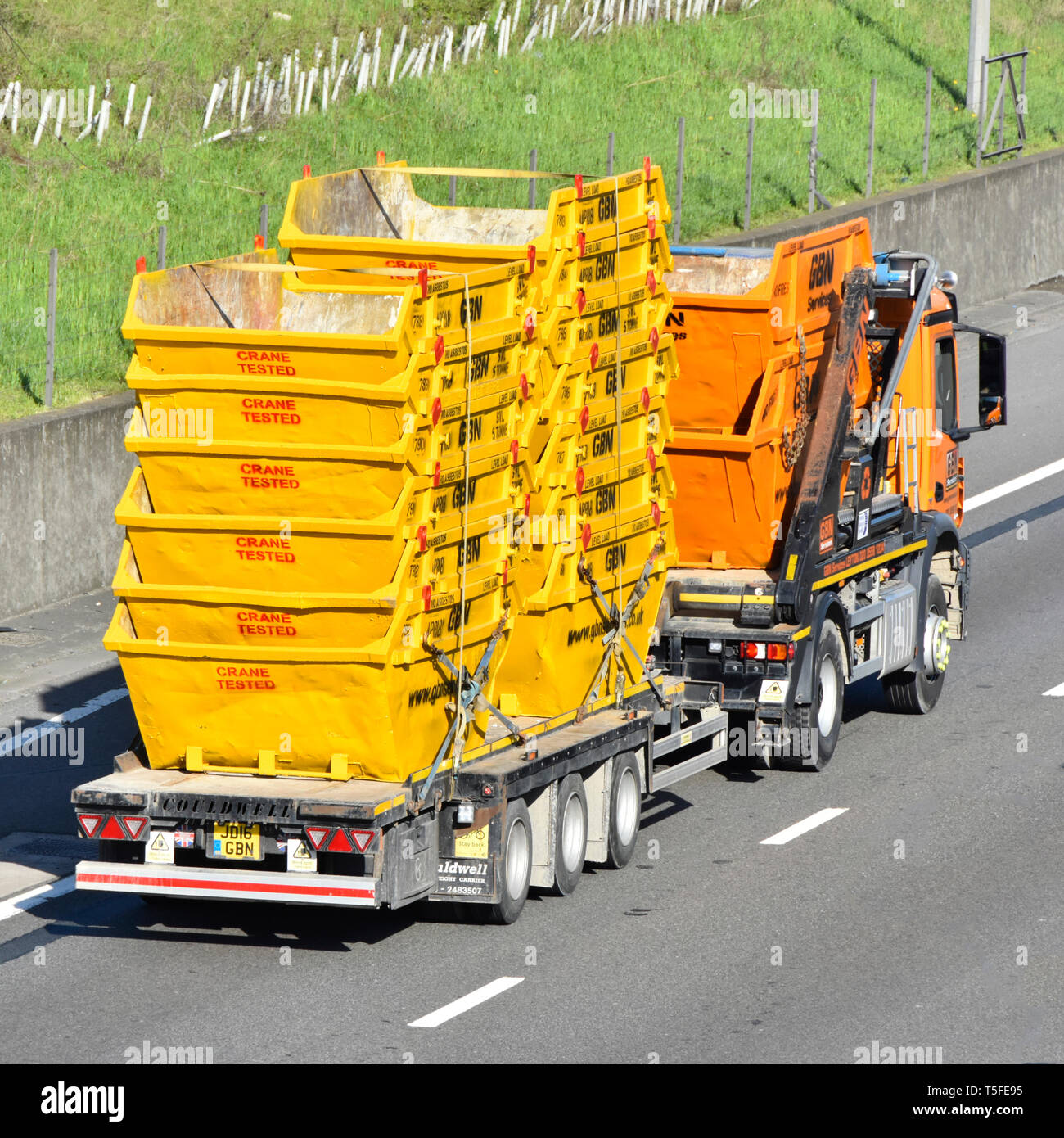 Skip lorry truck towing a trailer loaded with delivery of thirteen ...