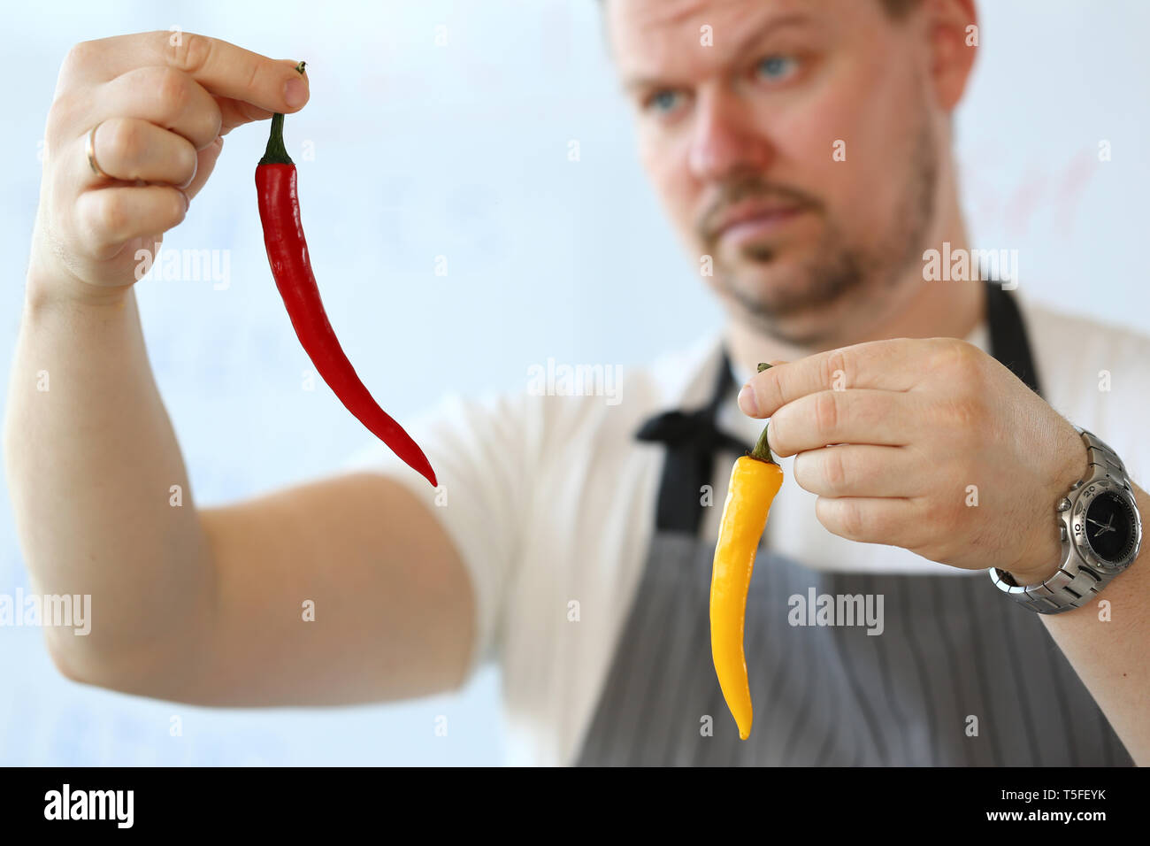 Professional Chef Showing Yellow Chili Pepper Stock Photo - Alamy