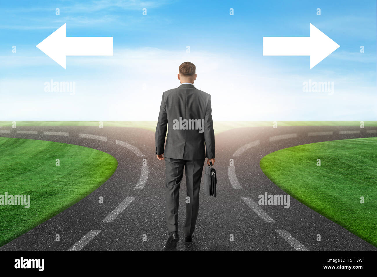 Businessman standing at crossroads with arrows. Concept of choice Stock ...