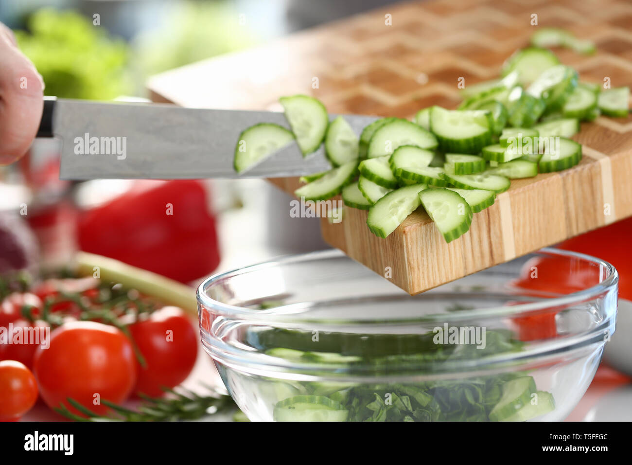 Organic Small Chopped Cucumber Slices Pouring Bowl Stock Photo - Alamy