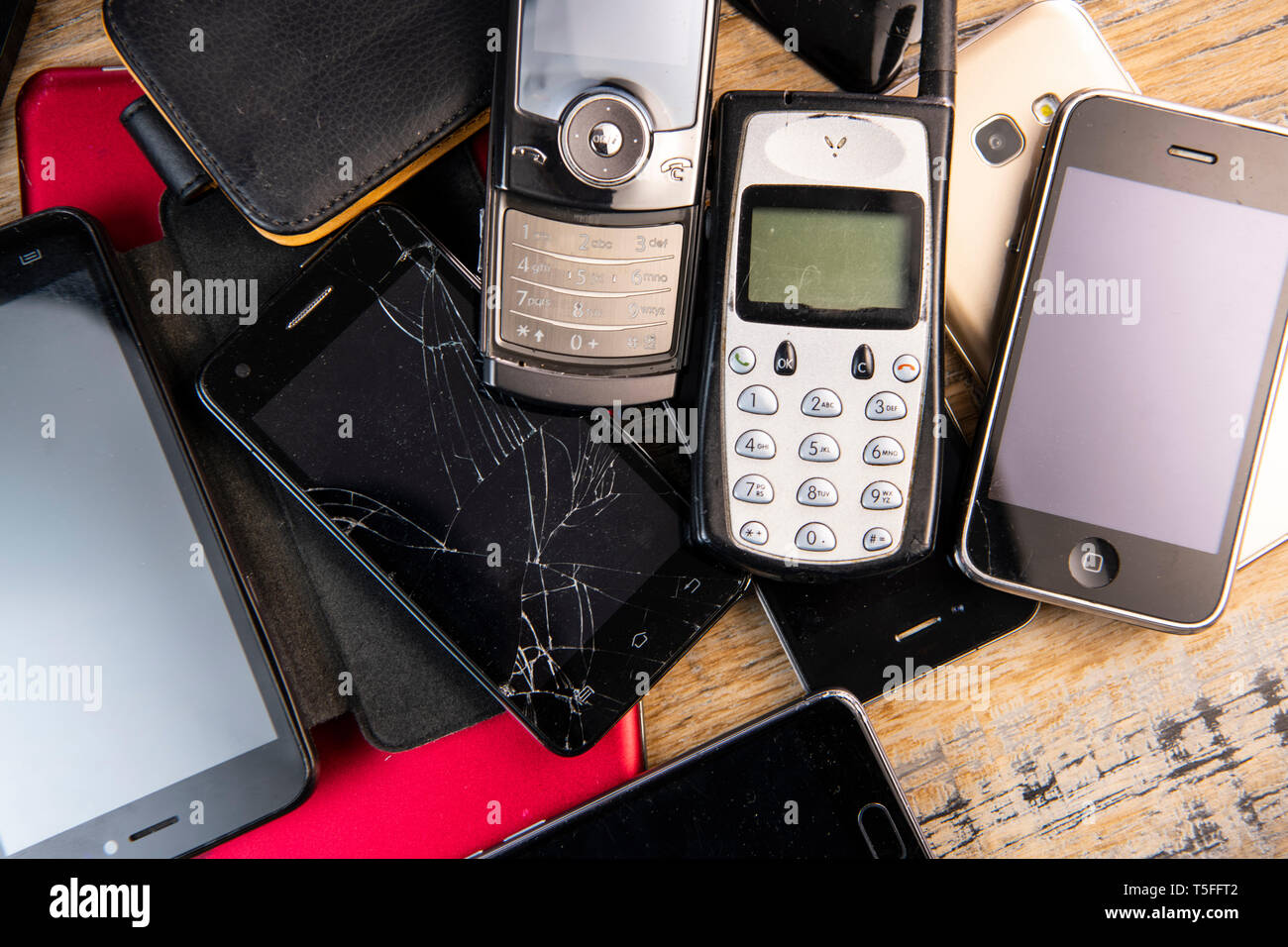 Old, broken and obsolete cellphone on wood background, France Stock ...