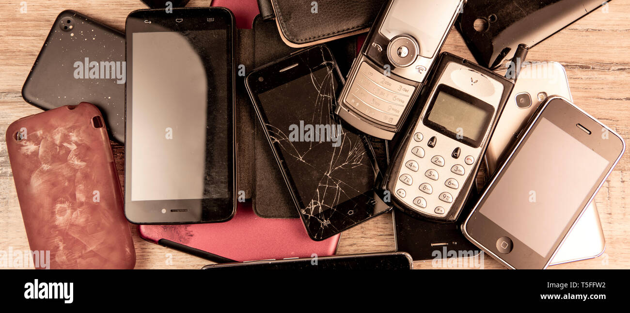 Old, broken and obsolete cellphone on wood background, France Stock ...