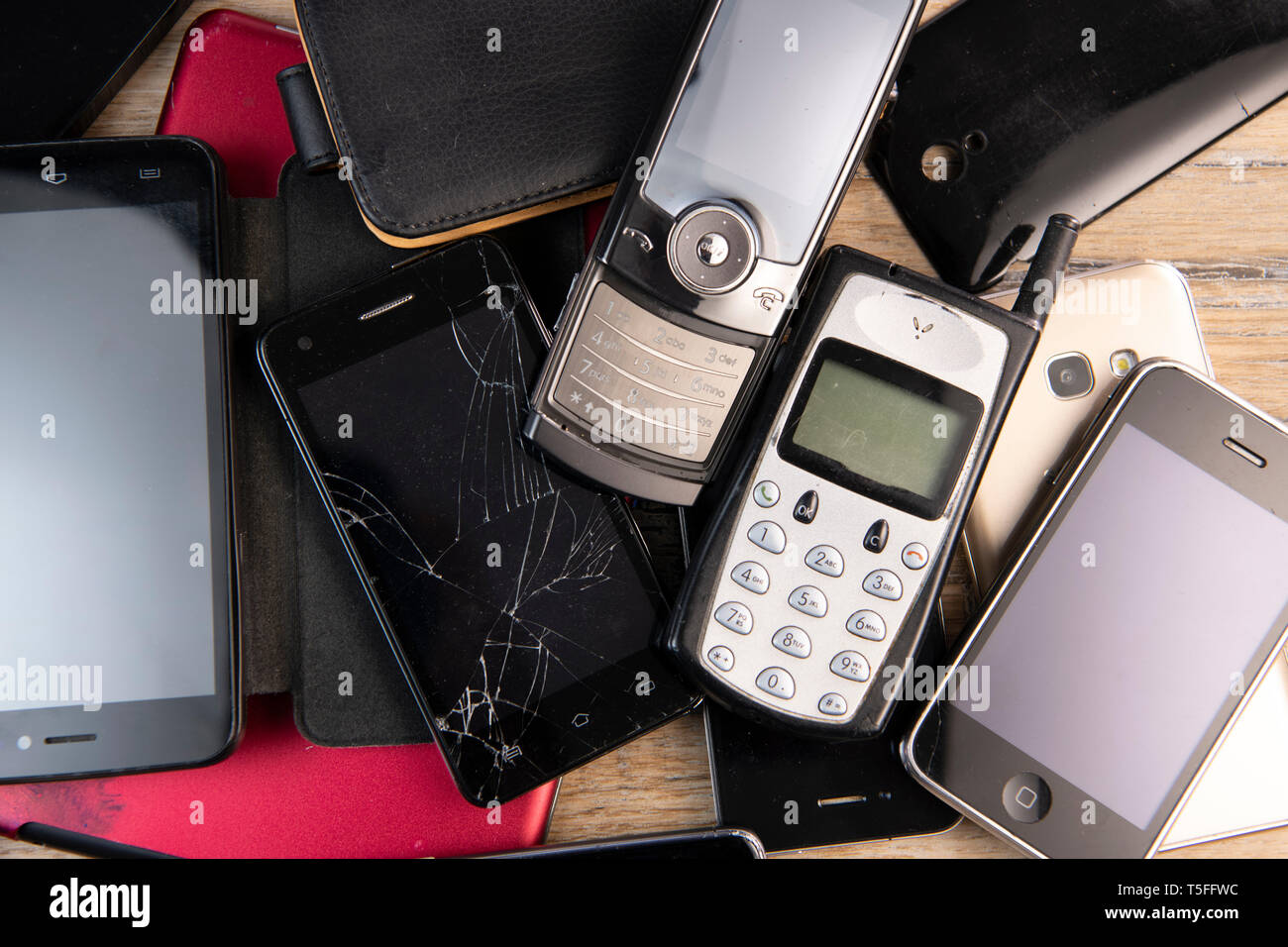 Old, broken and obsolete cellphone on wood background, France Stock ...