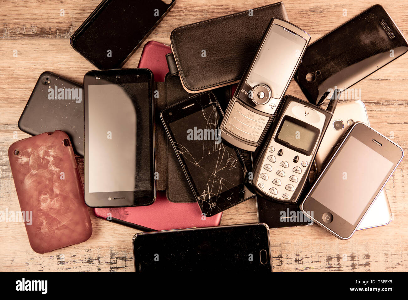 Old, broken and obsolete cellphone on wood background, France Stock ...