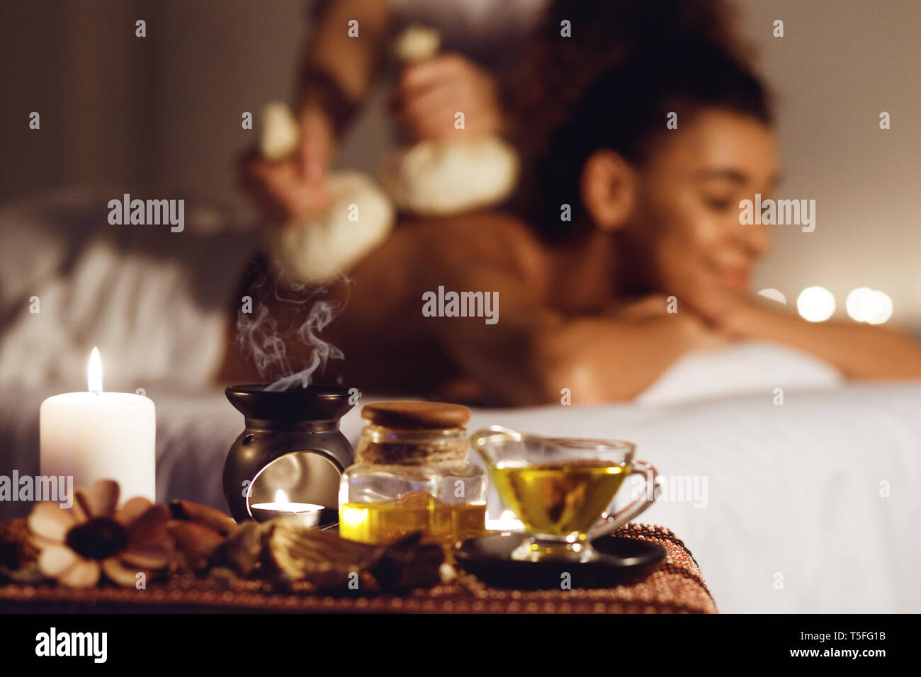 Woman getting thai herbal compress massage in spa Stock Photo - Alamy