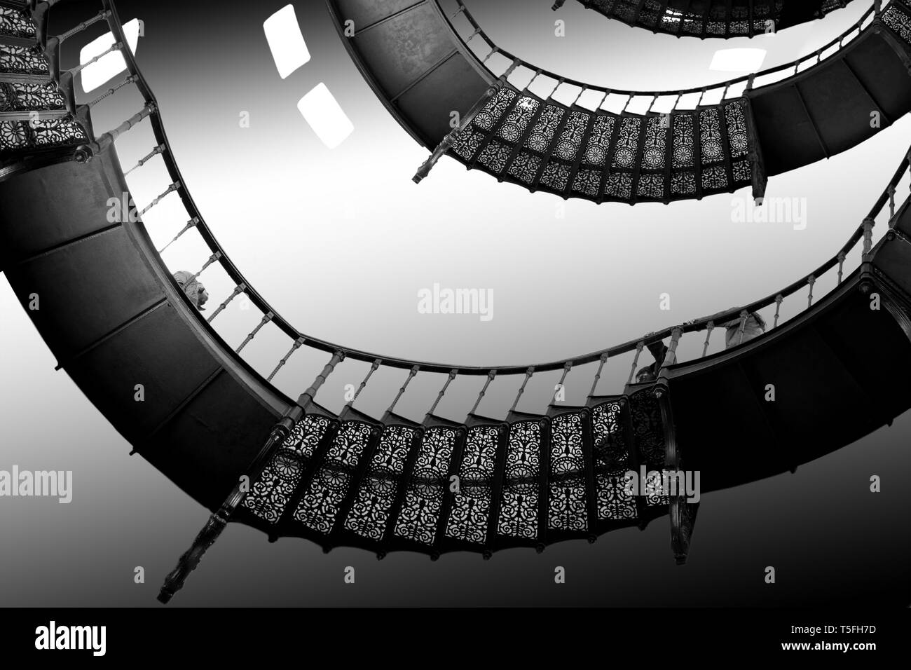 The abstract photography of people going up and down a spiral staircase ...
