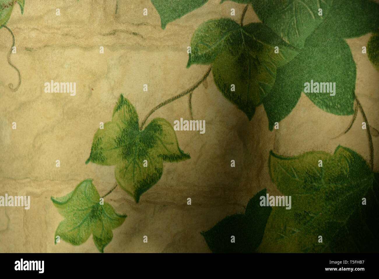 Paper background with gray bricks and green painted ivy and ivy leaves ...