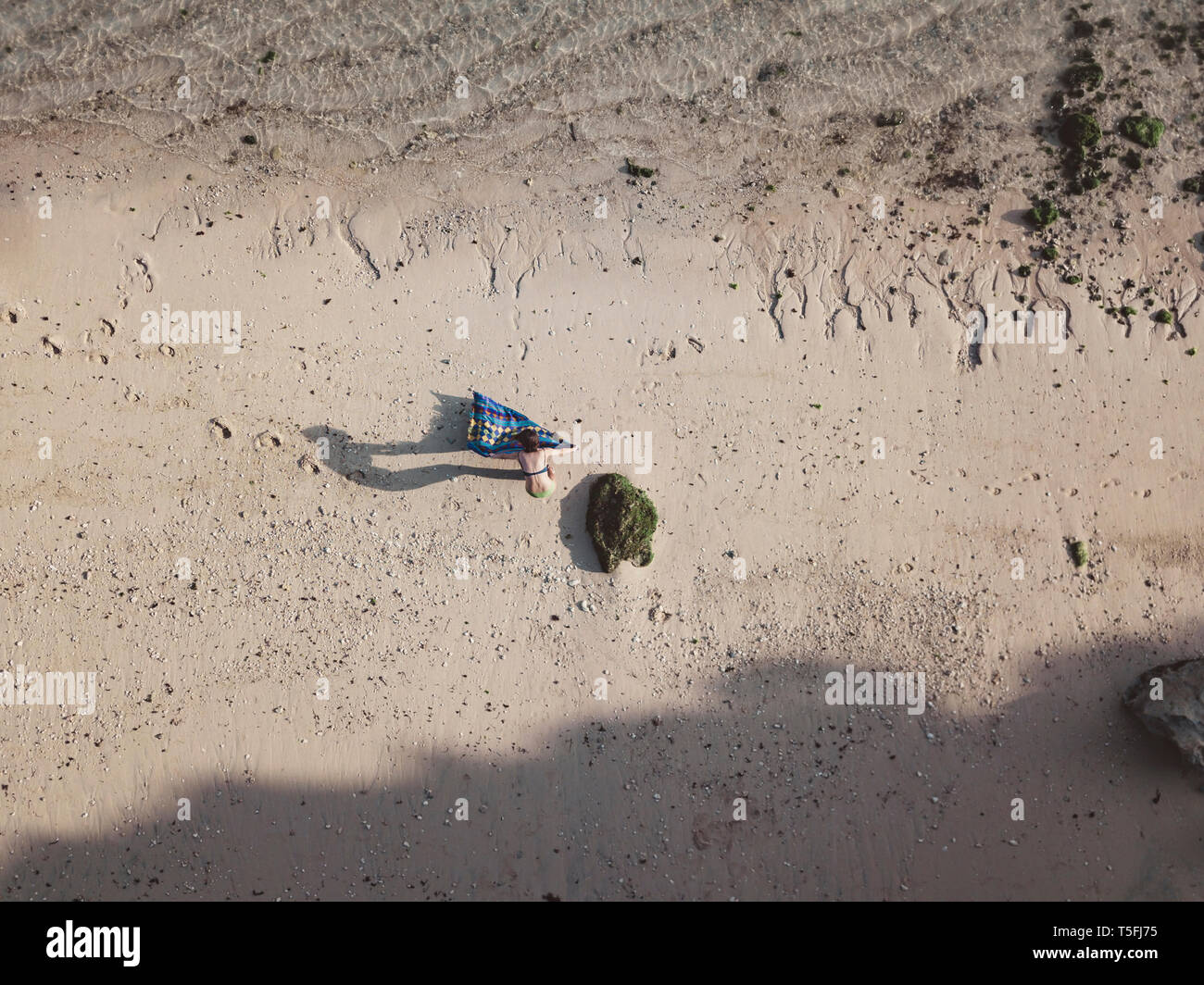 Back woman putting towel beach hi-res stock photography and images - Alamy
