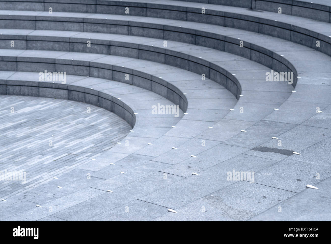 Curved stone seating part of The Scoop outdoor amphitheatre in London ...