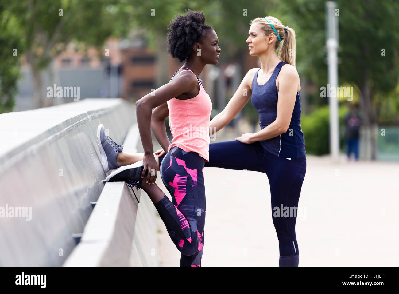Two women stretching in hi-res stock photography and images - Alamy