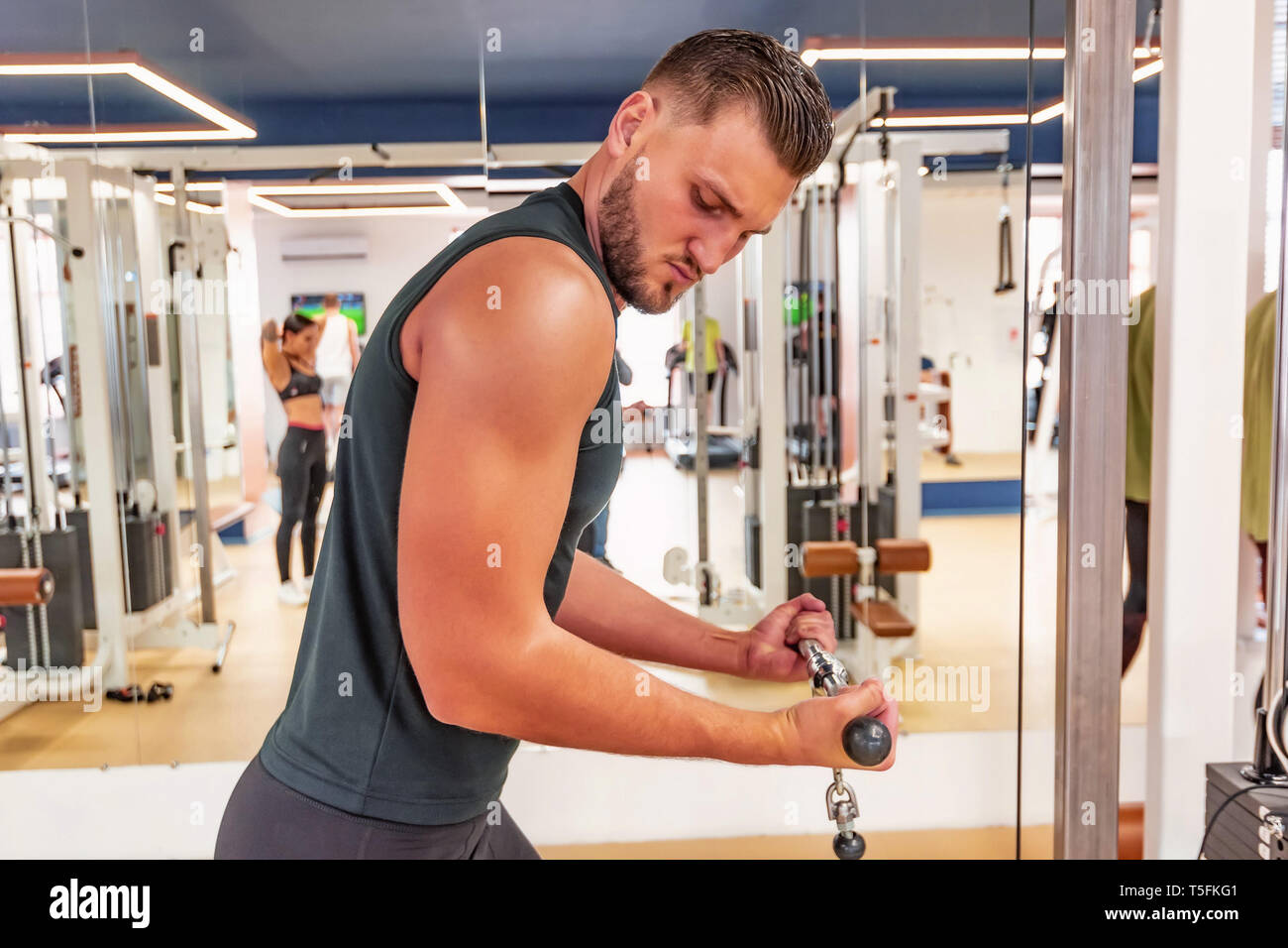 Young handsome man does lat pull up exercise in gym Stock Photo - Alamy