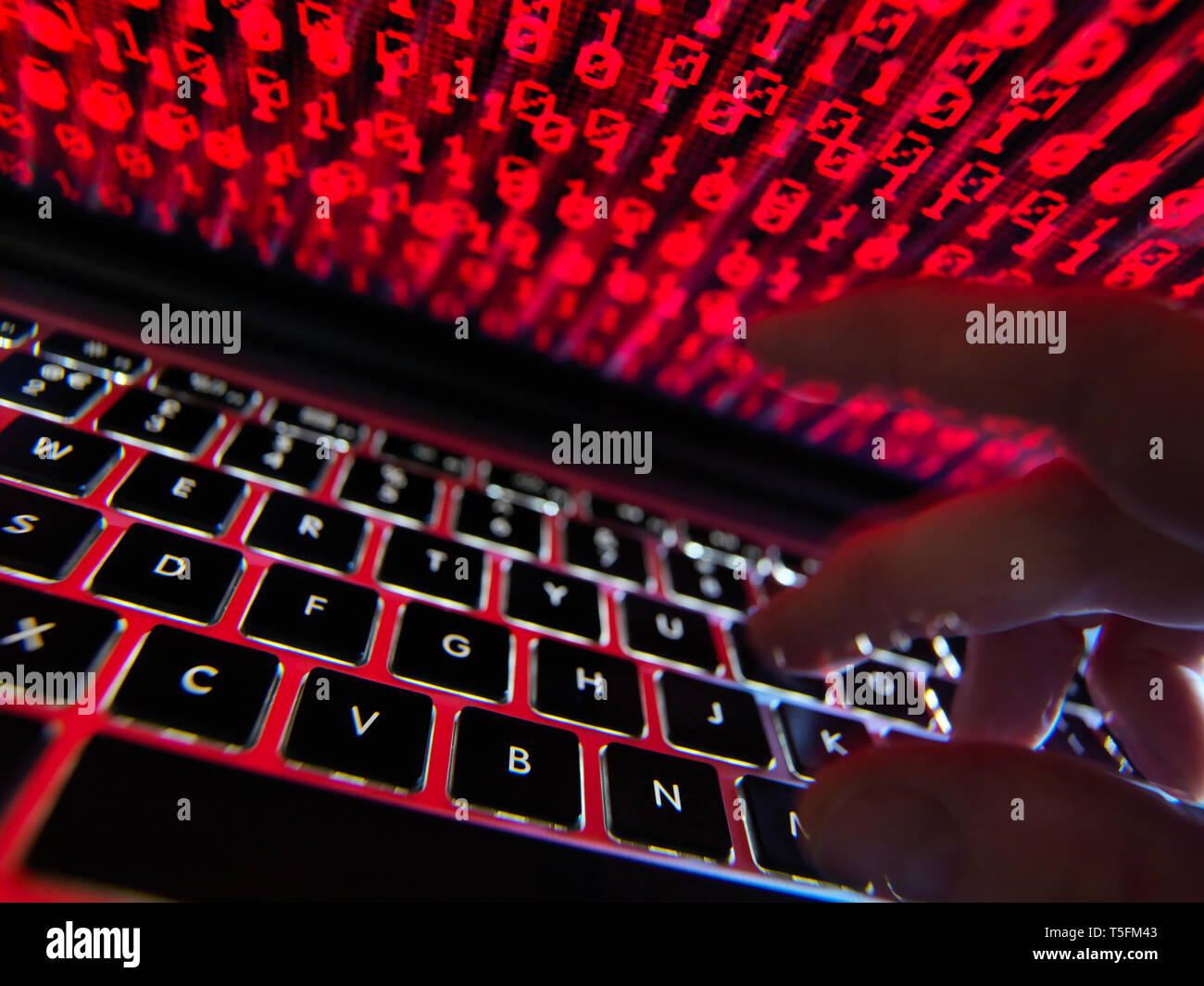 Hacker coding a computer virus infecting a laptop Stock Photo - Alamy