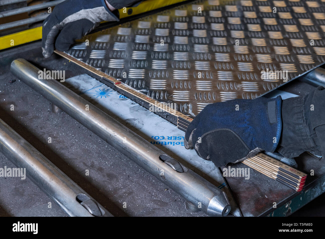 Two hands working with steel and a steel cutter Stock Photo - Alamy
