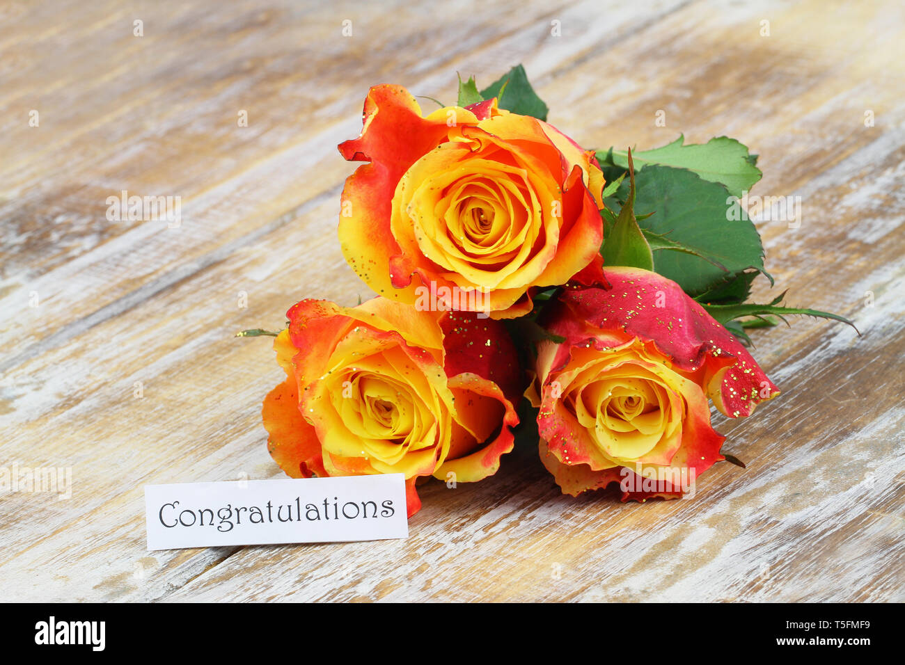 Congratulations card with three orange roses with glitter on rustic ...