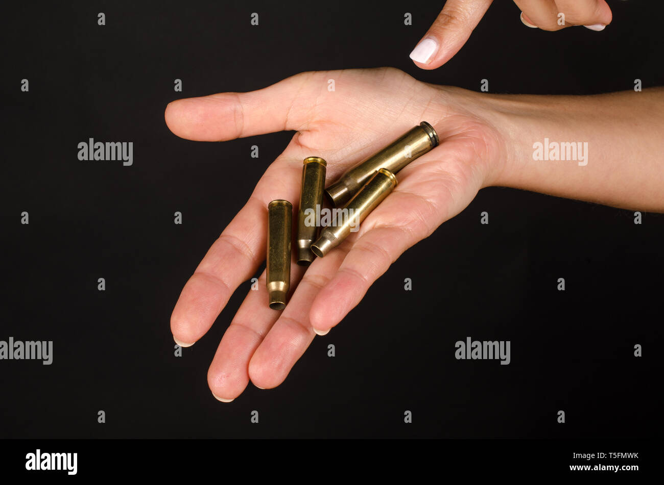 Female hand with bullet shells, a concept Stock Photo - Alamy