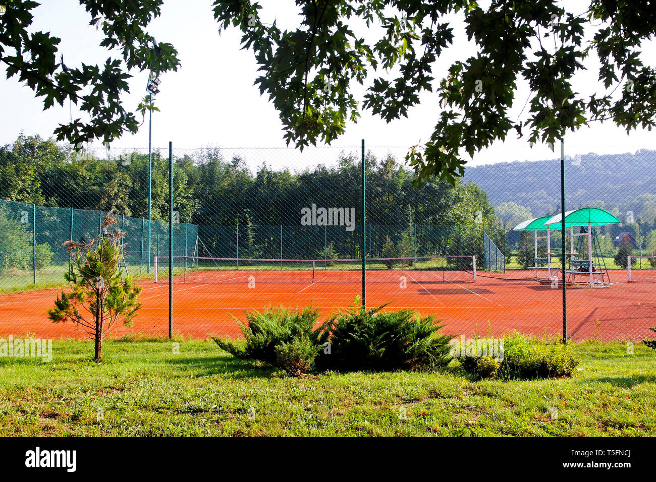 Orange tennis court sport terrain in park Stock Photo - Alamy