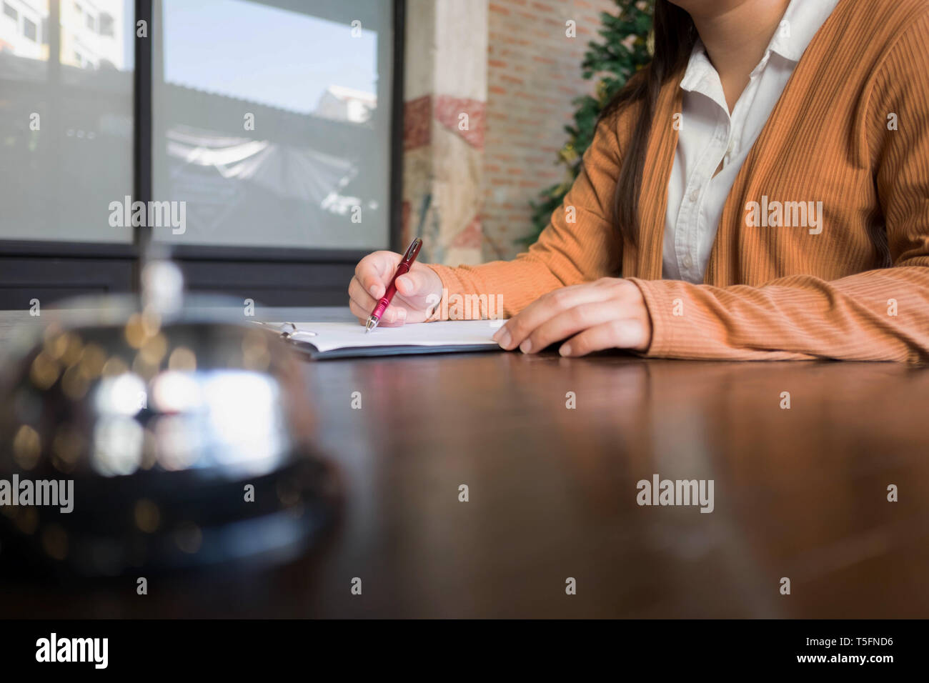 Woman filling form reception desk hi-res stock photography and images ...