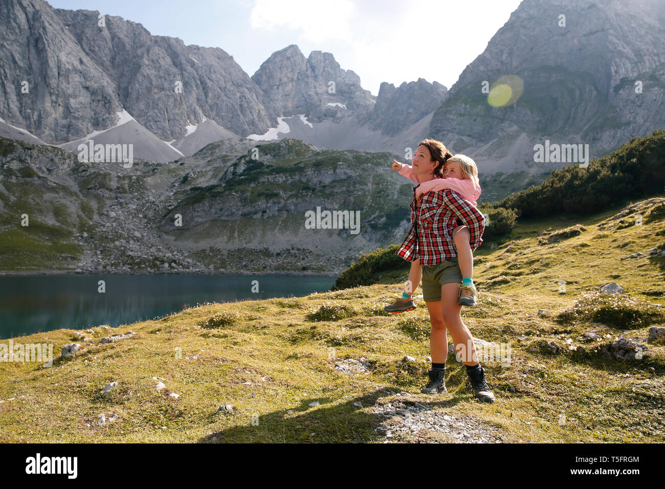 Mother carrying daughter piggyback lake drachensee hi-res stock ... Mother carrying daughter piggyback lake drachensee hi-res stock ...